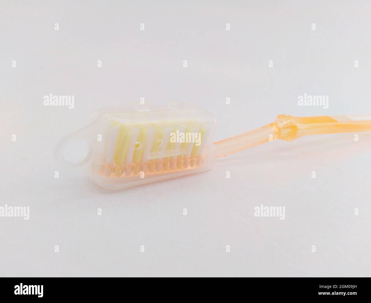 Used toothbrush on an isolated white background Stock Photo - Alamy