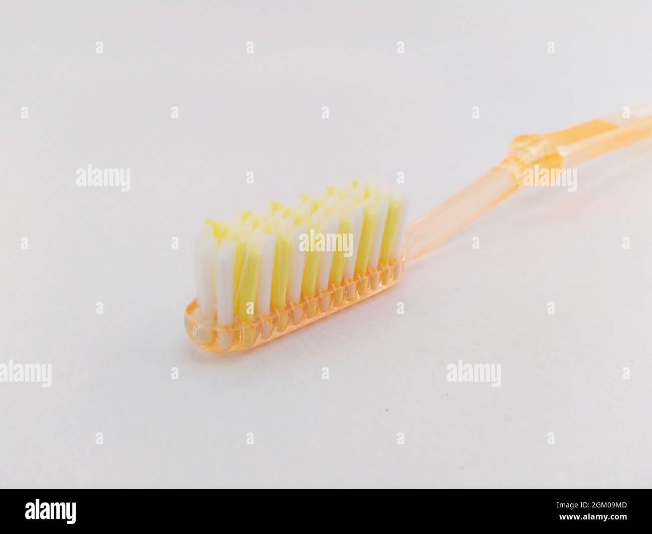 Used toothbrush on an isolated white background Stock Photo - Alamy