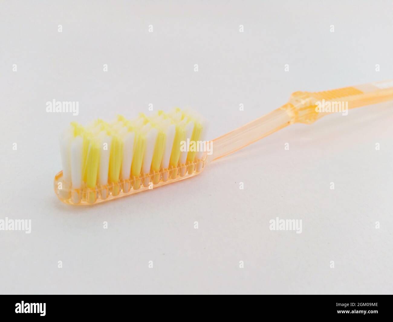 Used toothbrush on an isolated white background Stock Photo - Alamy