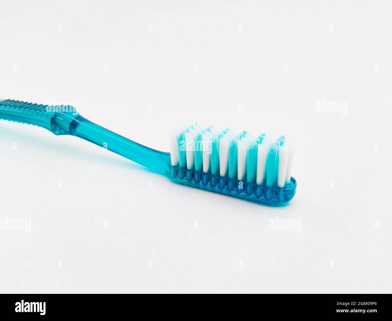 Used toothbrush on an isolated white background Stock Photo - Alamy
