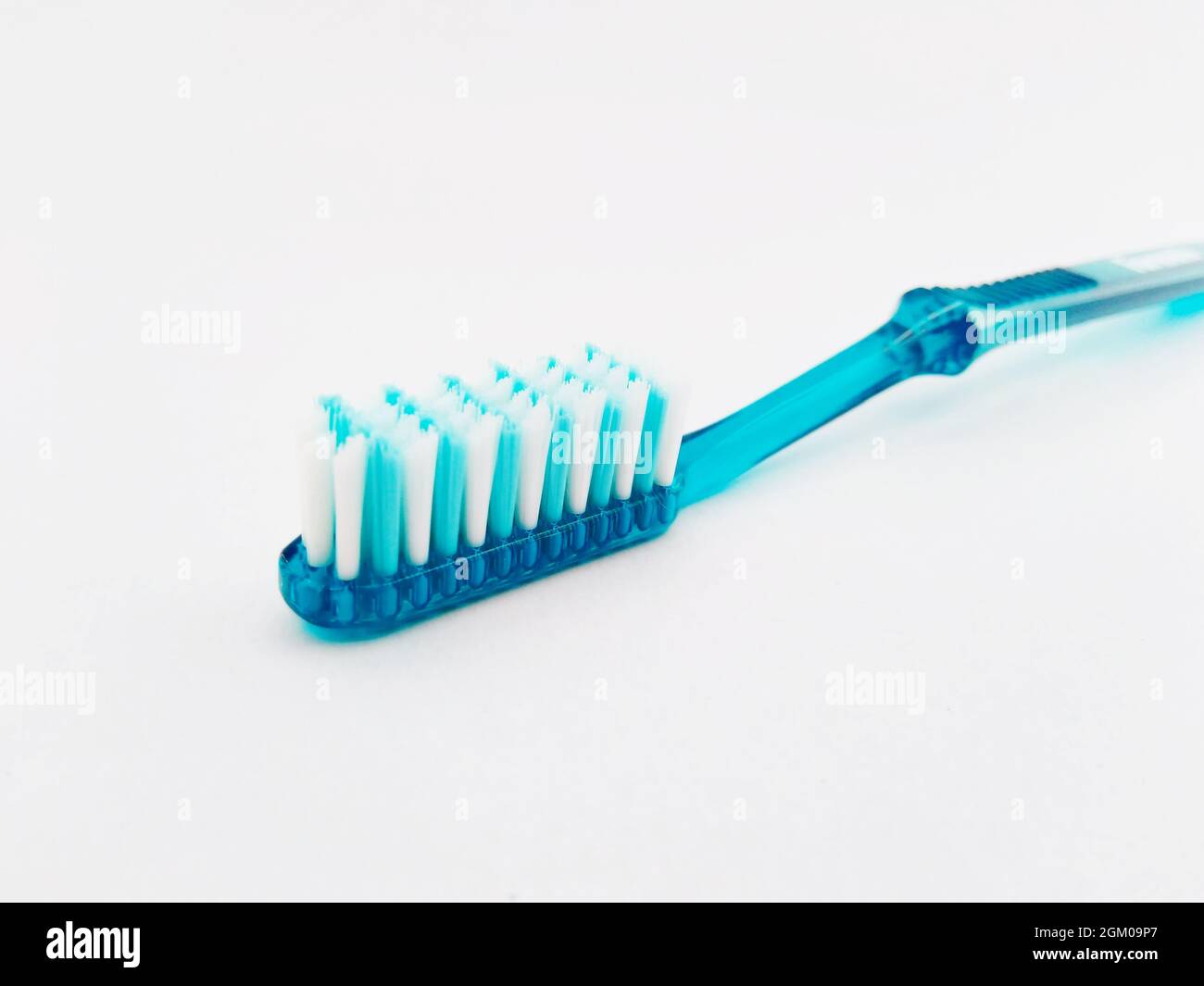 Used toothbrush on an isolated white background Stock Photo - Alamy
