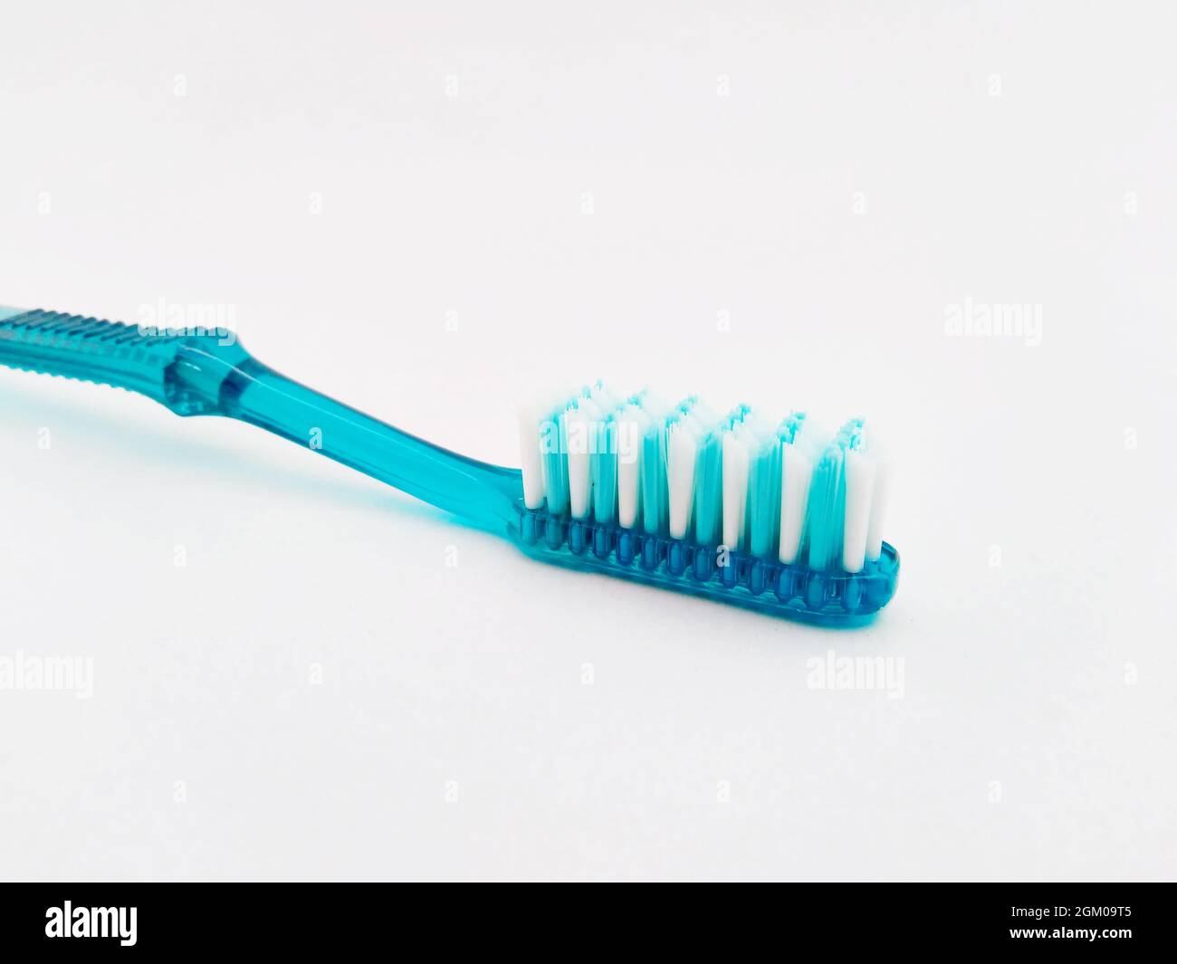Used toothbrush on an isolated white background Stock Photo - Alamy