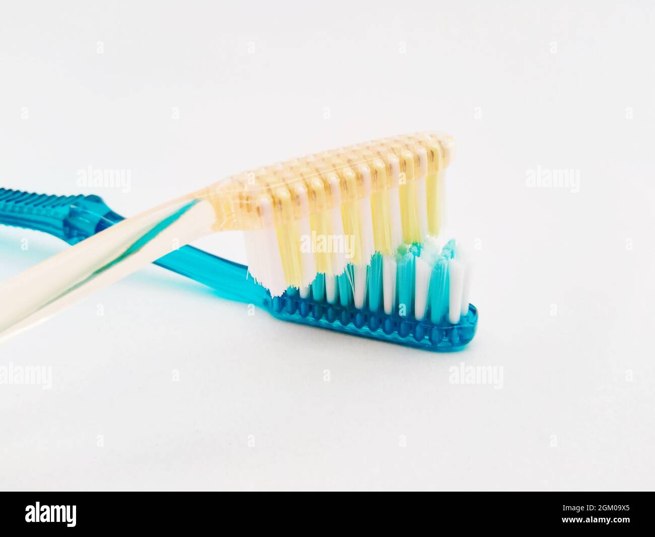 Used toothbrush on an isolated white background Stock Photo - Alamy