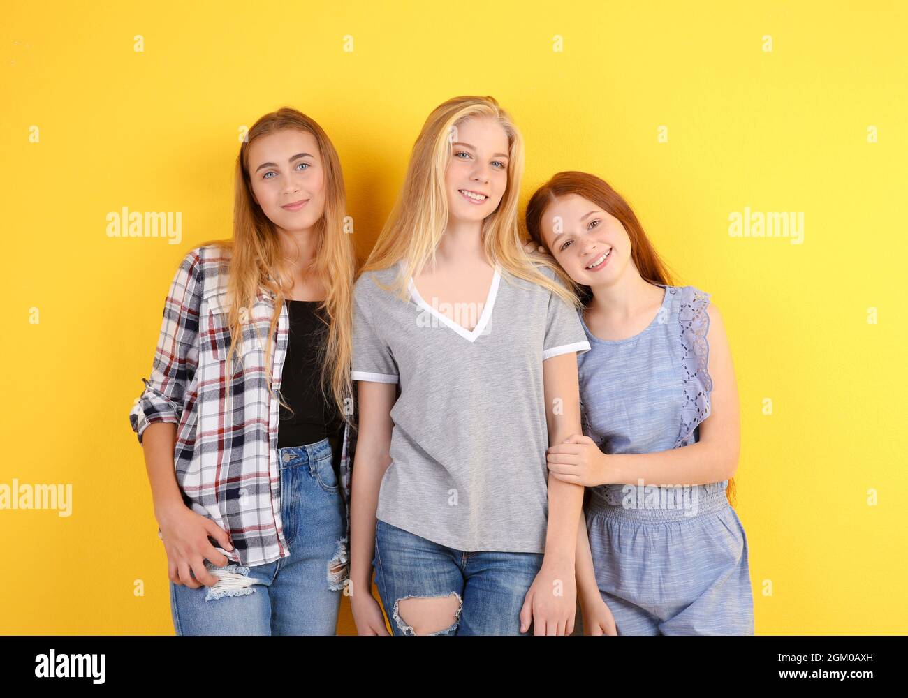 Cute teenagers on color background Stock Photo - Alamy