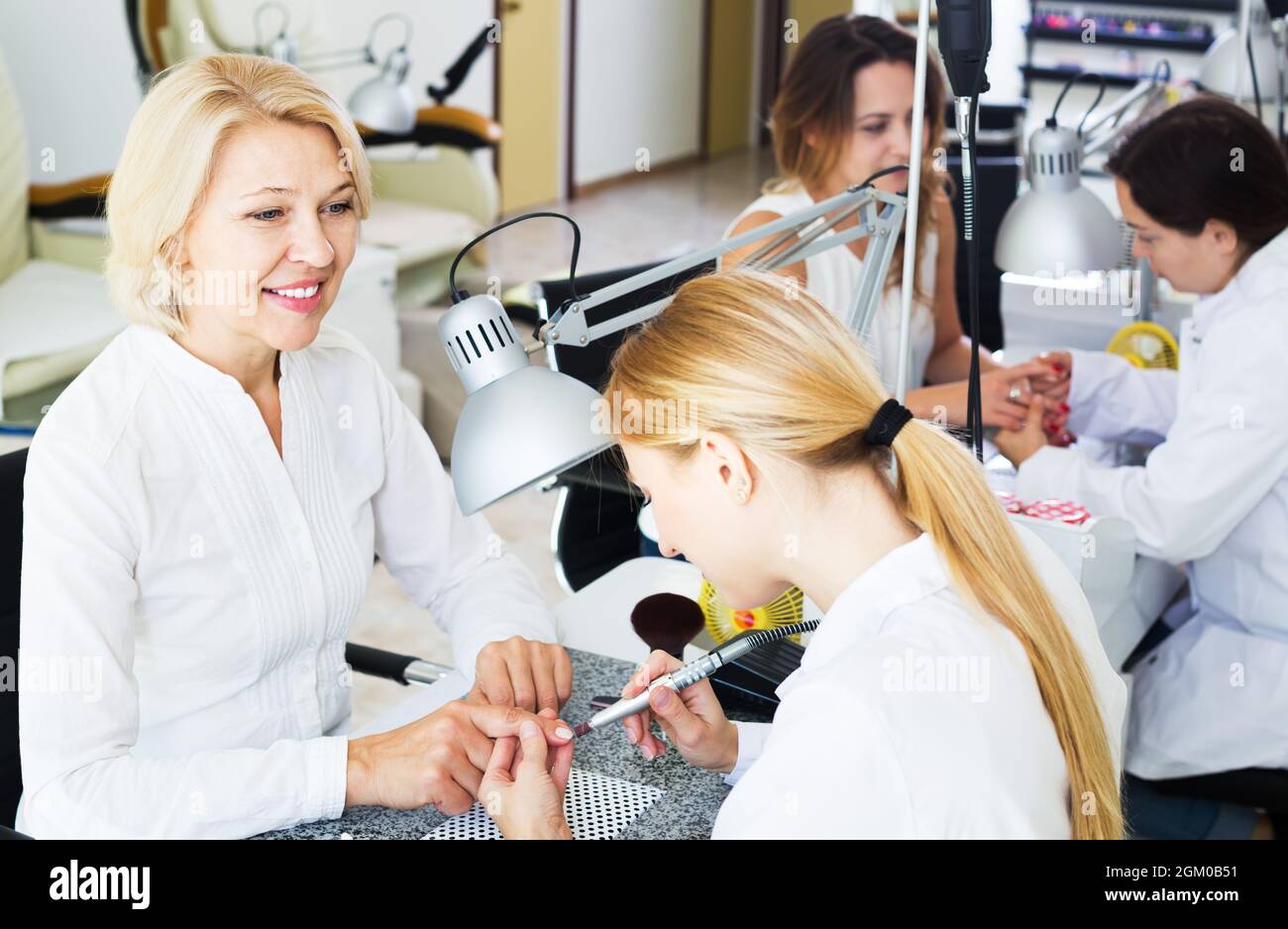 Women clients in nail salon Stock Photo - Alamy