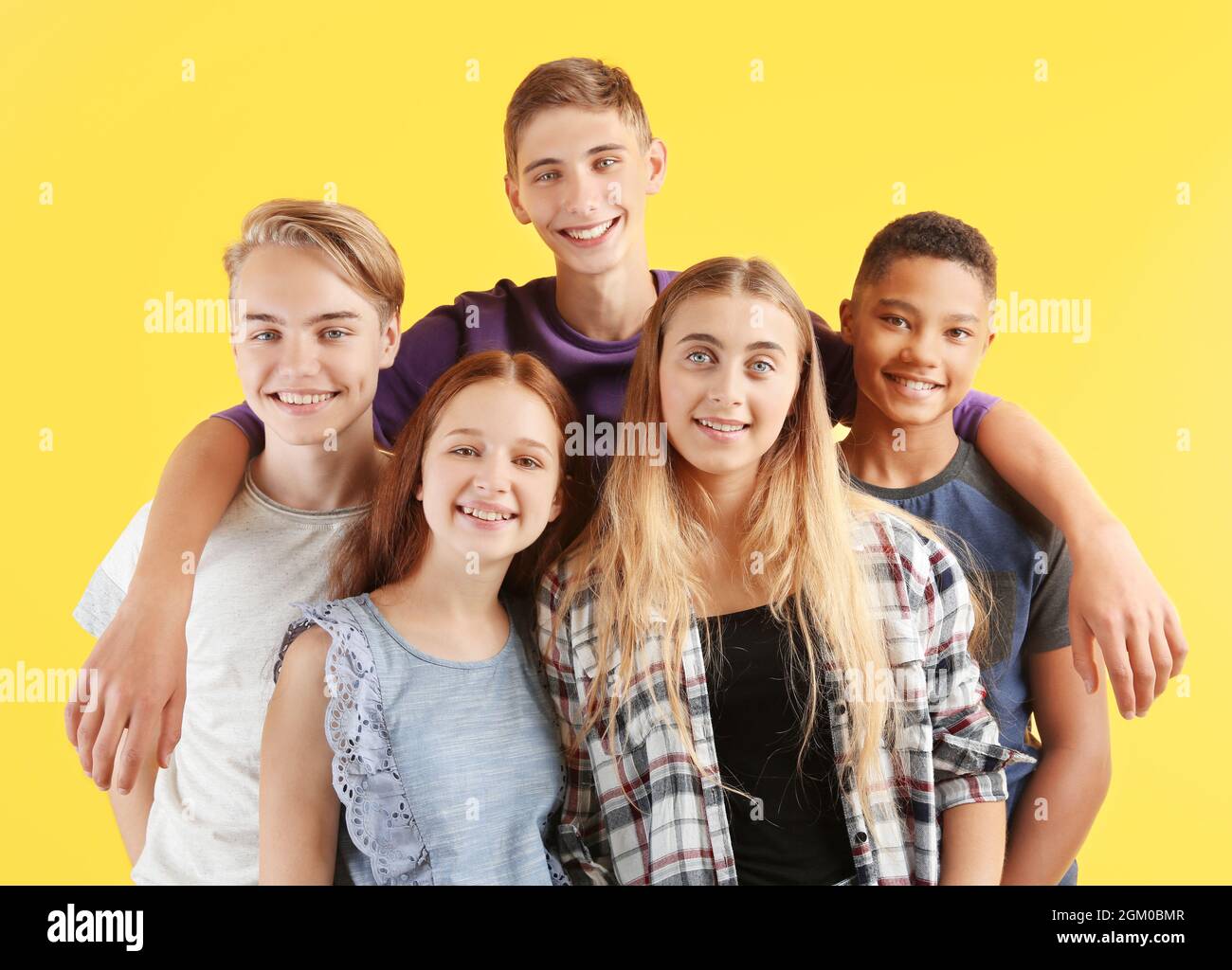 Cute teenagers on color background Stock Photo - Alamy