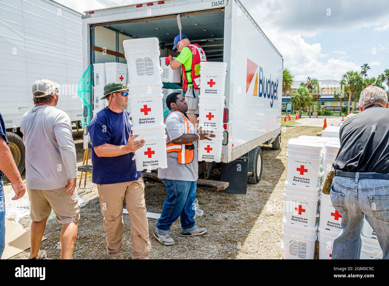 Volunteers workers black man men unloading hi-res stock photography and ...