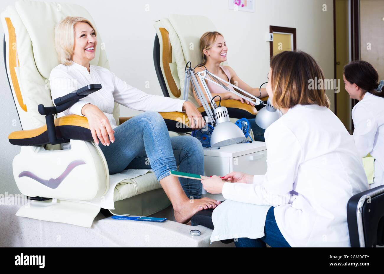Women doing pedicure Stock Photo - Alamy