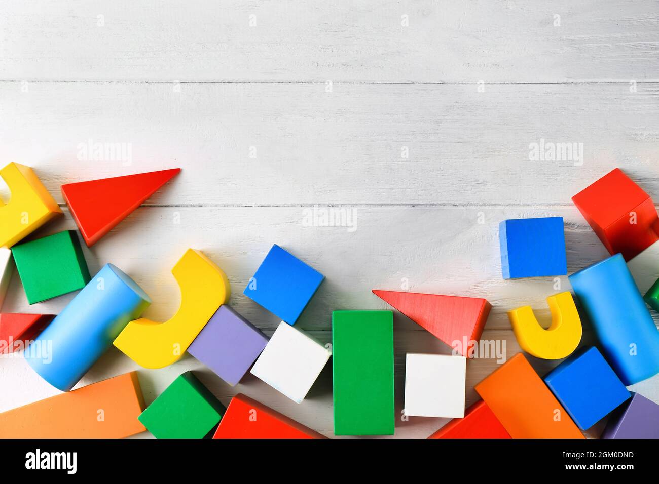 Colorful blocks of different shapes on wooden background Stock Photo ...