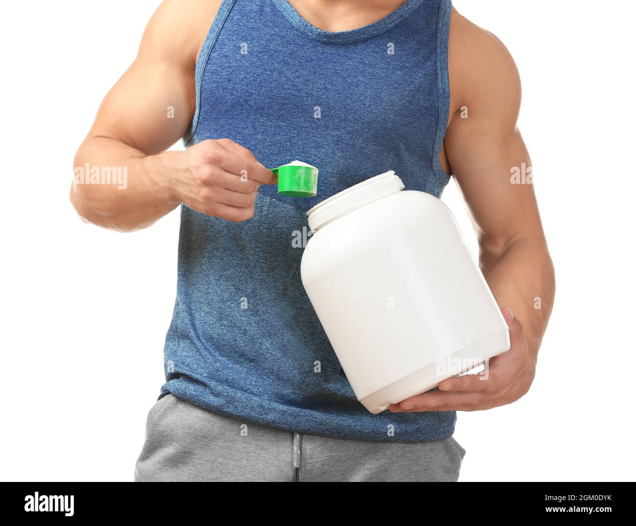 Sporty young man with jar and scoop of protein powder on white ...