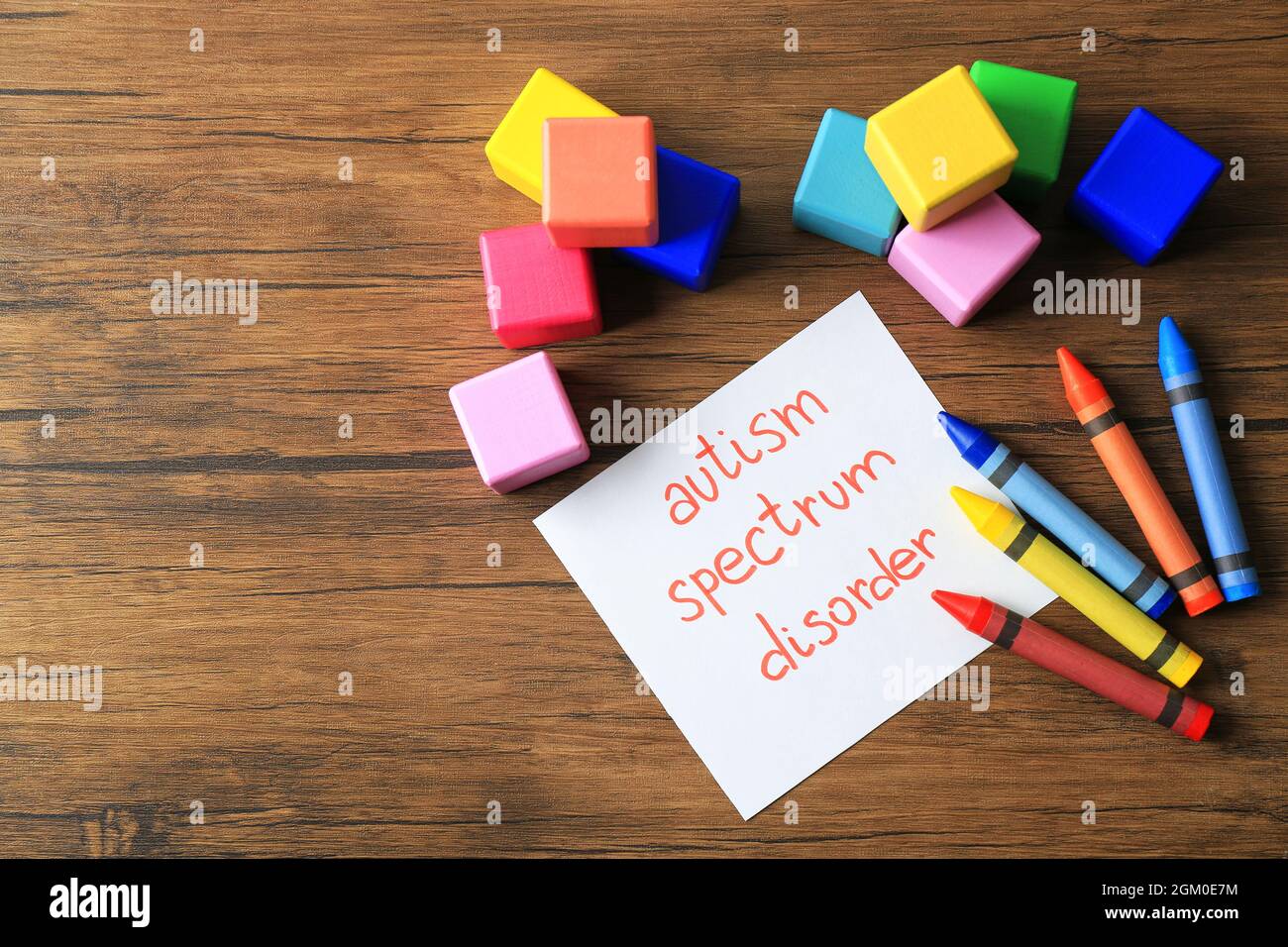 Colorful pencils, cubes and paper with words Autism spectrum disorder ...
