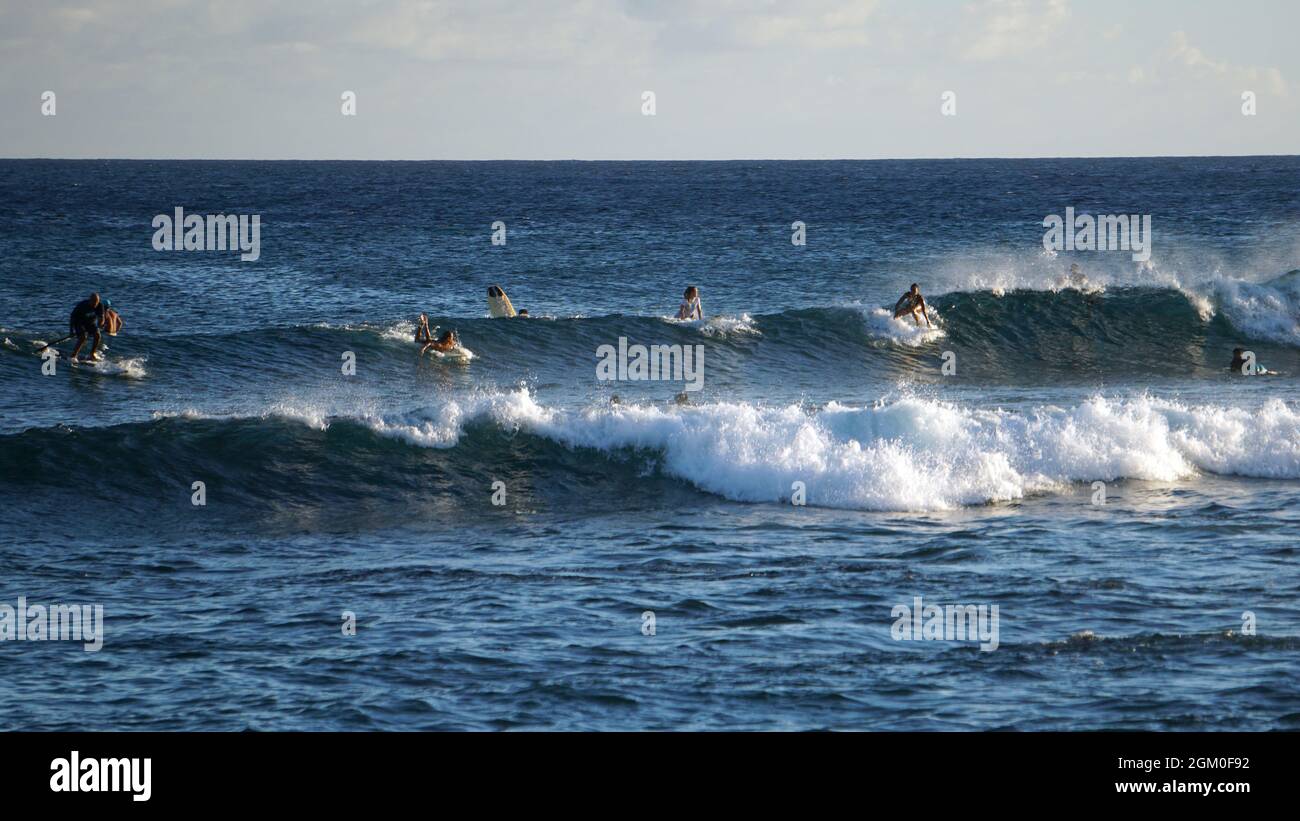 Surfers ride the waves at Waiohai Beach on Kauai's south shore Stock ...
