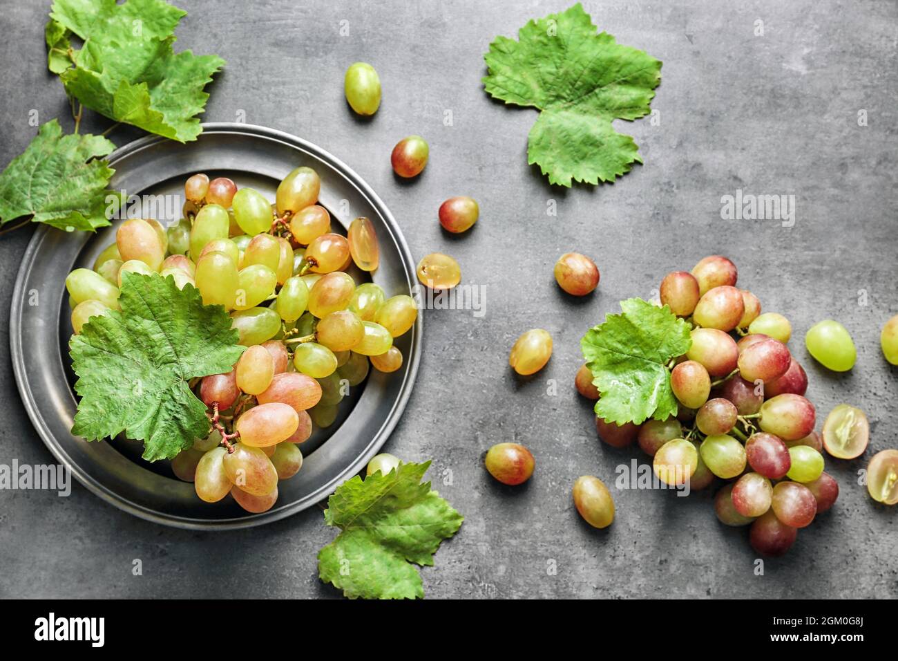Fresh ripe grapes on textured background Stock Photo - Alamy