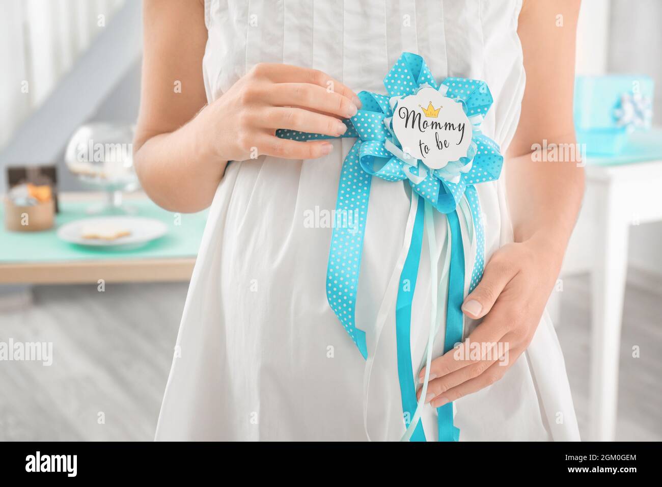 Pregnant woman with award ribbon on belly, closeup Stock Photo - Alamy