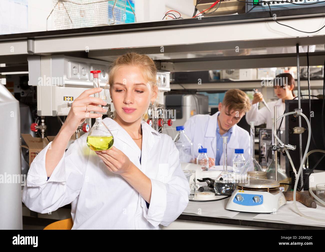 Female lab technician working with reagents Stock Photo - Alamy