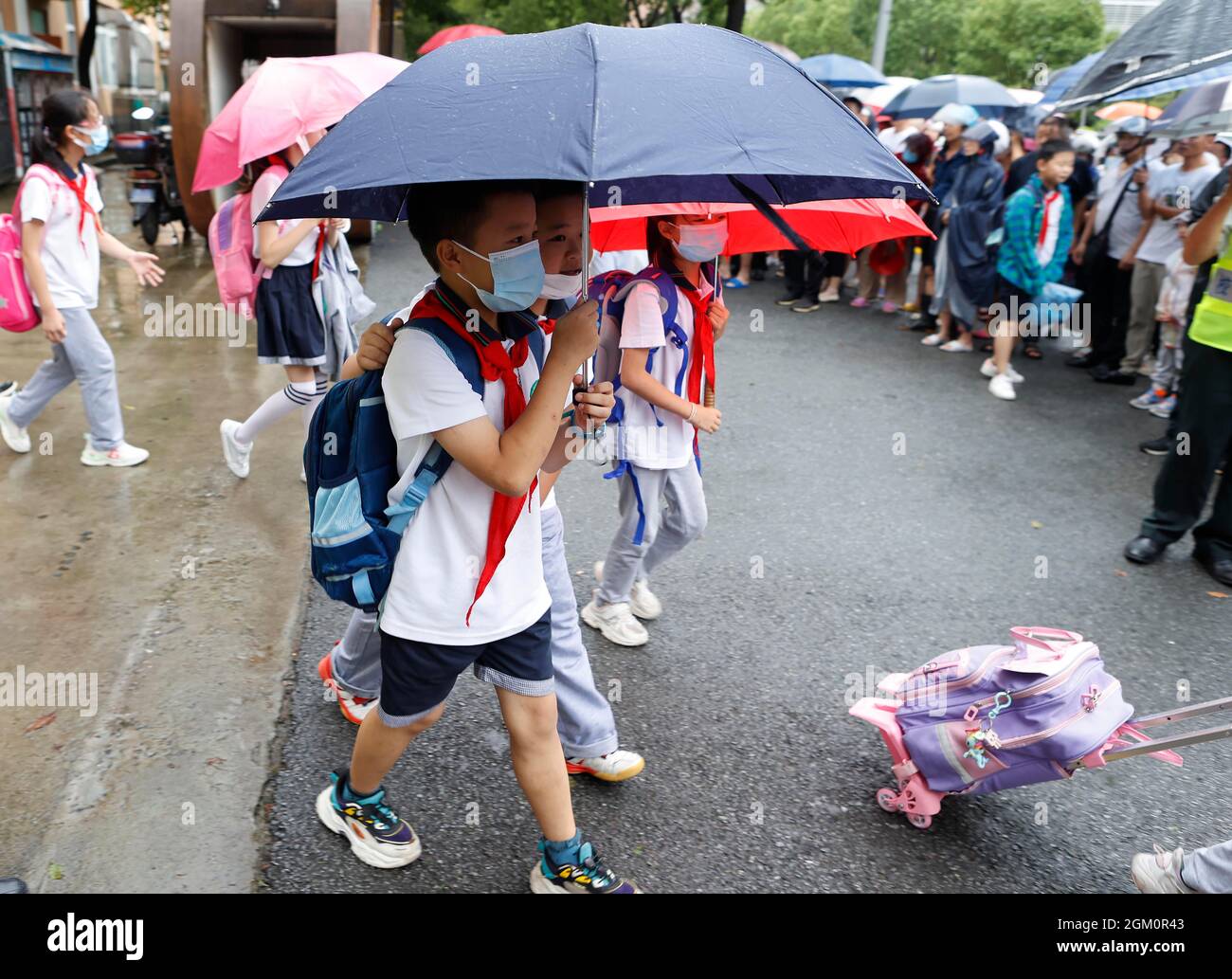 Parents pick up kids as classes are canceled due to Typhoon Chanthu ...