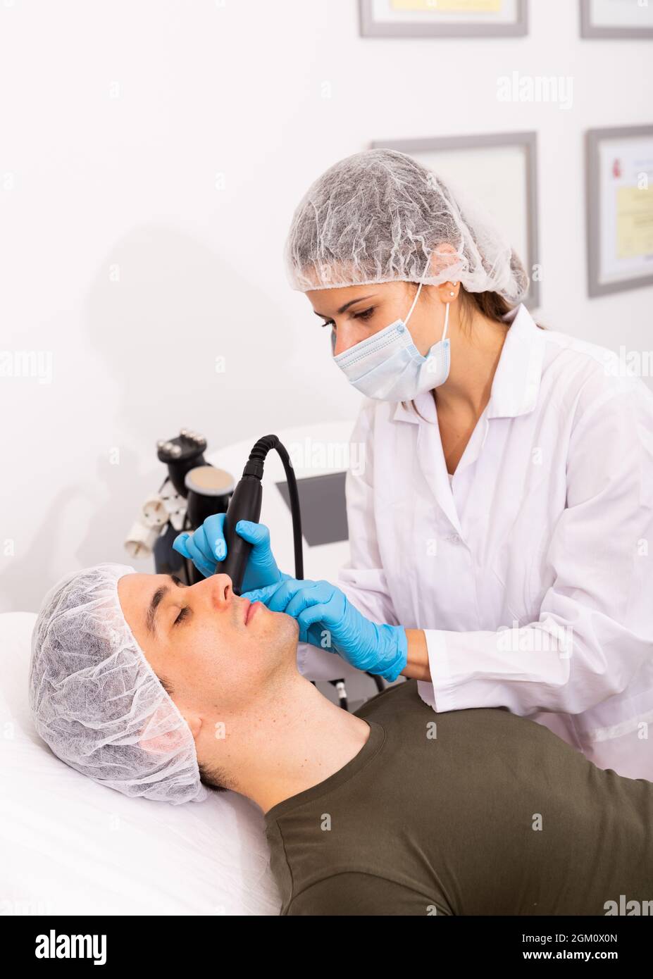 Man getting face ultrasound lifting procedure Stock Photo - Alamy