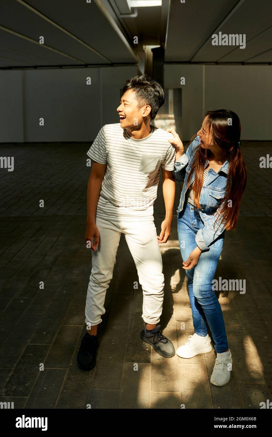 Laughing young people praciticing dance before filming viral video for ...