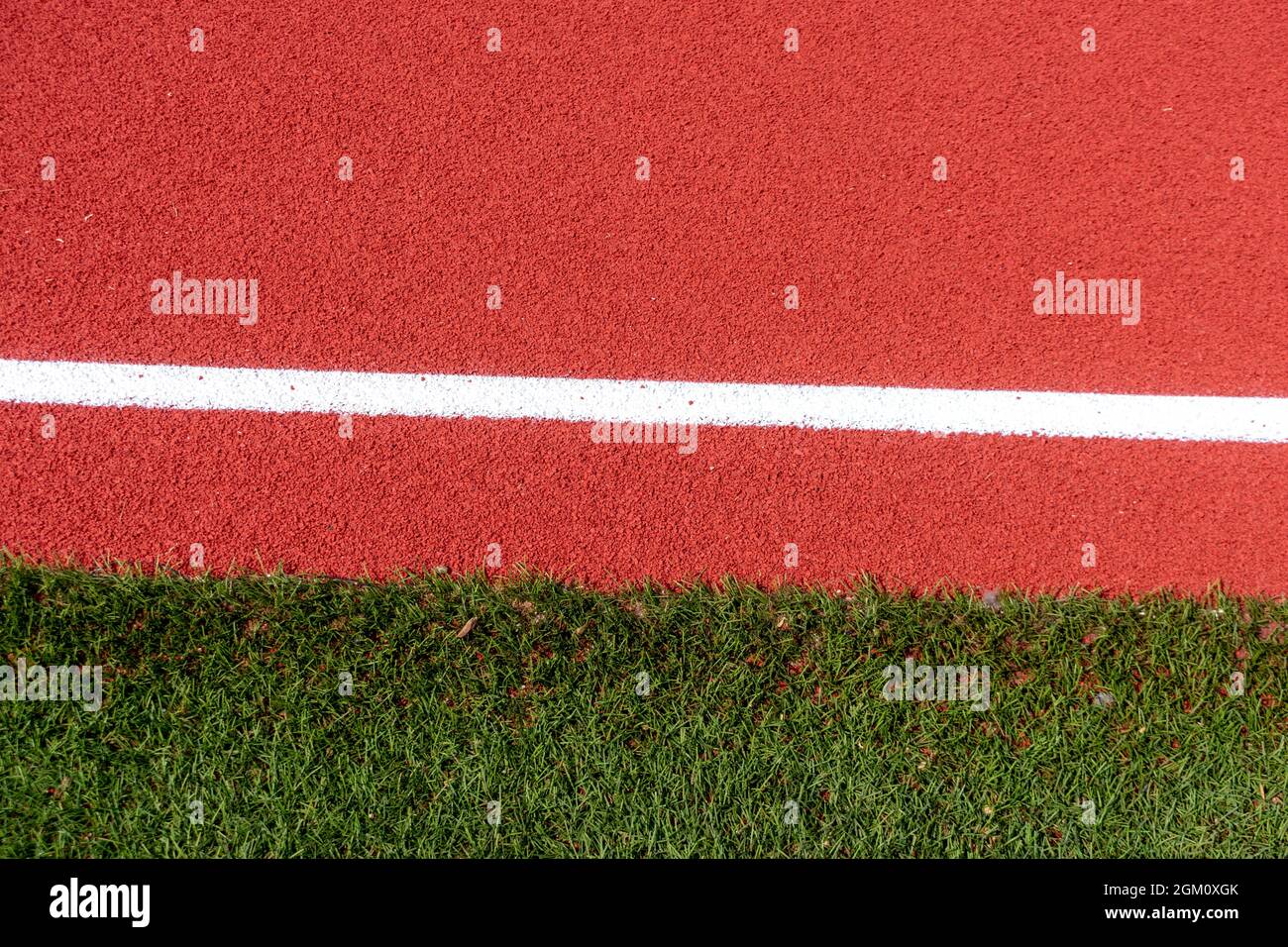 Running racetrack red rubber and eco-friendly green artificial grass ...