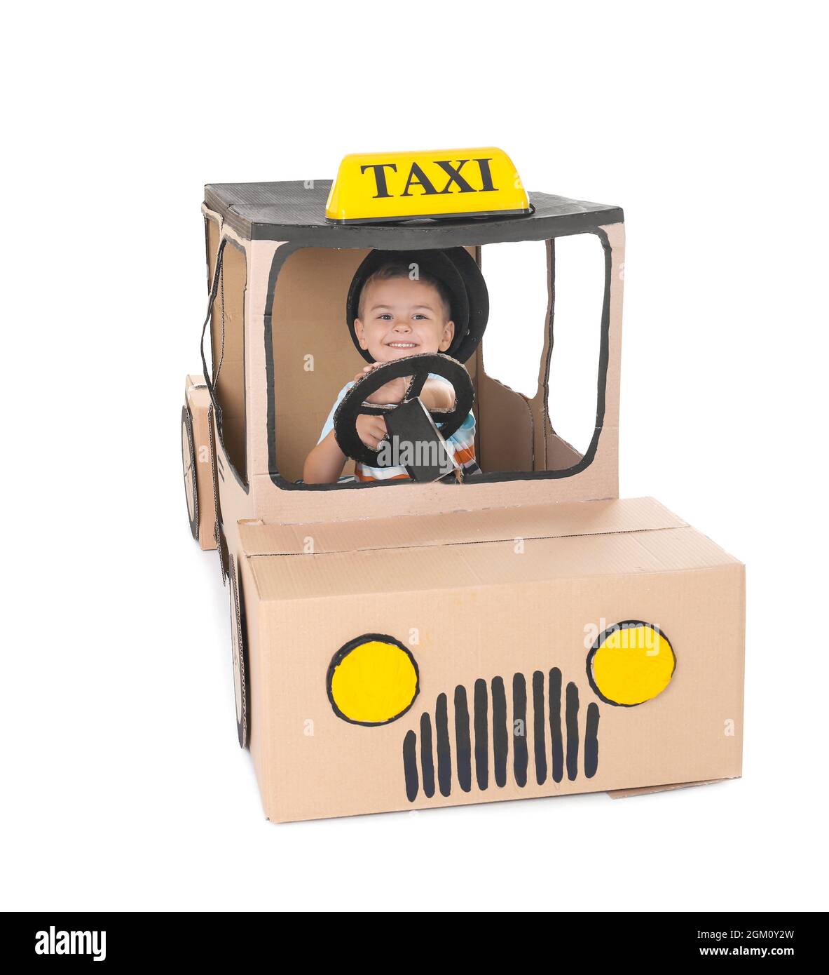 Little boy playing with cardboard taxi on white background Stock Photo ...