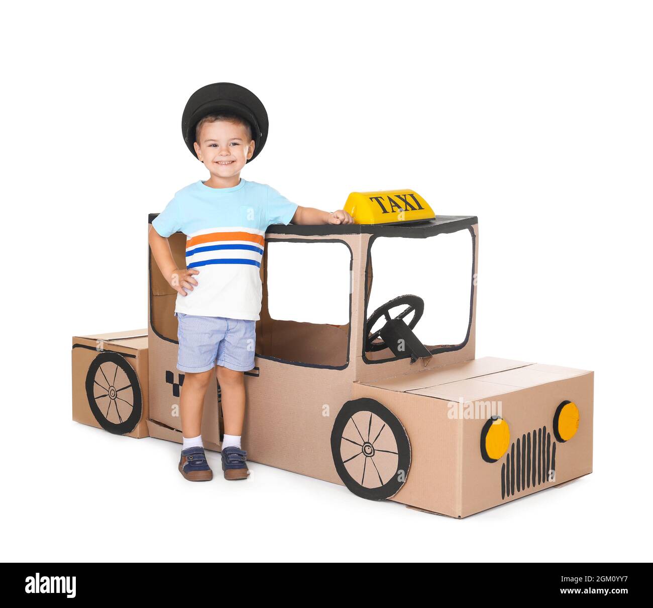 Little boy playing with cardboard taxi on white background Stock Photo ...