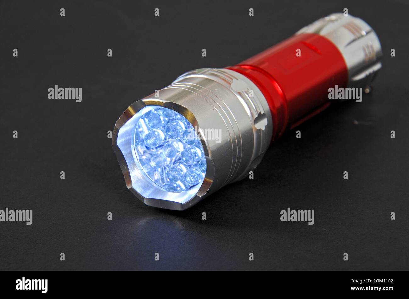 Illuminated LED torch against a plain background Stock Photo - Alamy