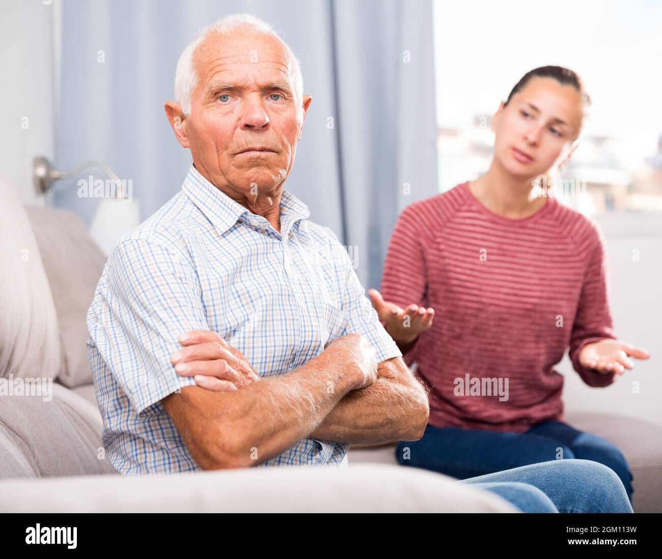 Portrait of upset senior man and daughter quarrelling at home Stock ...