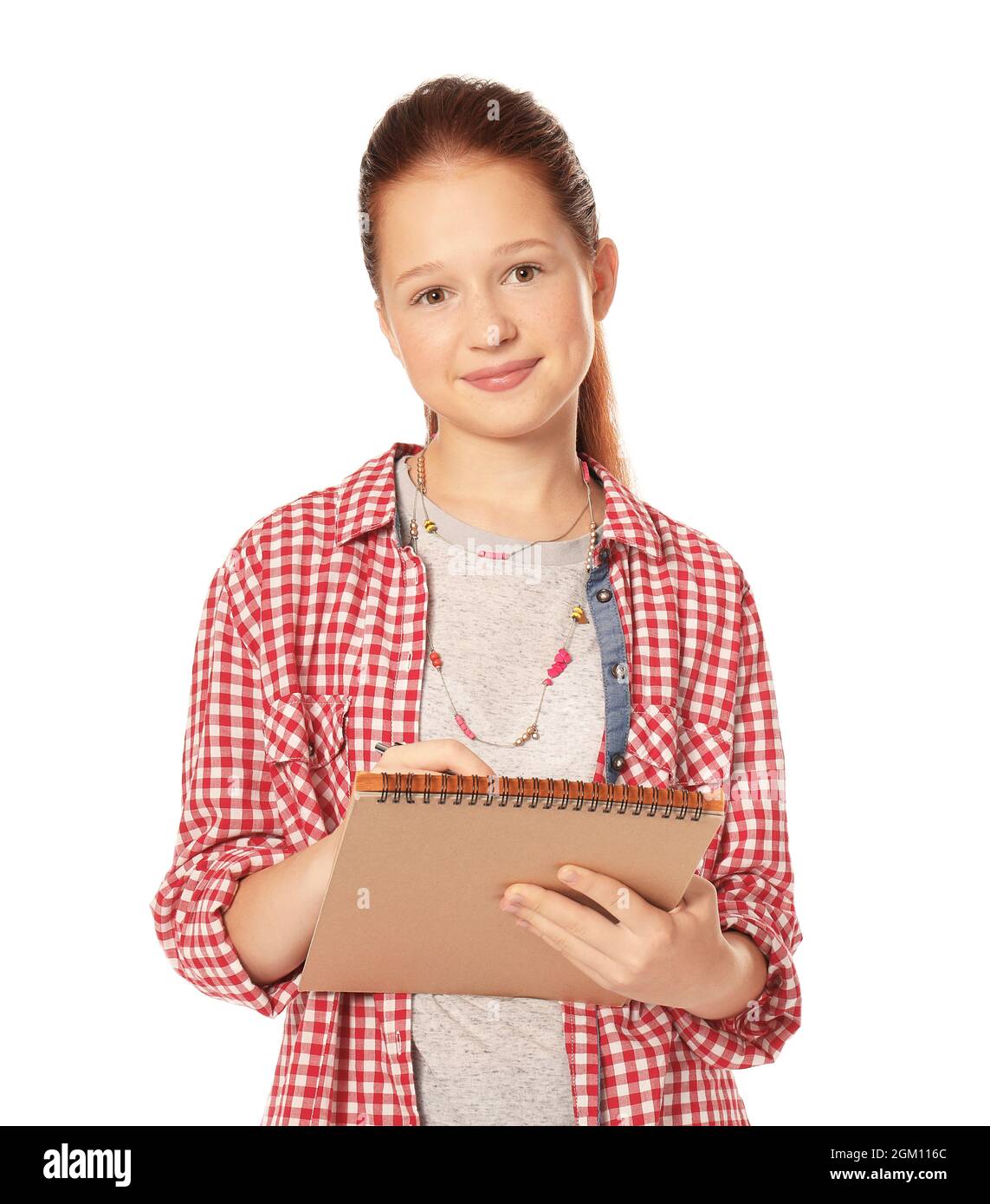 Cute teenager girl making notes on white background Stock Photo - Alamy