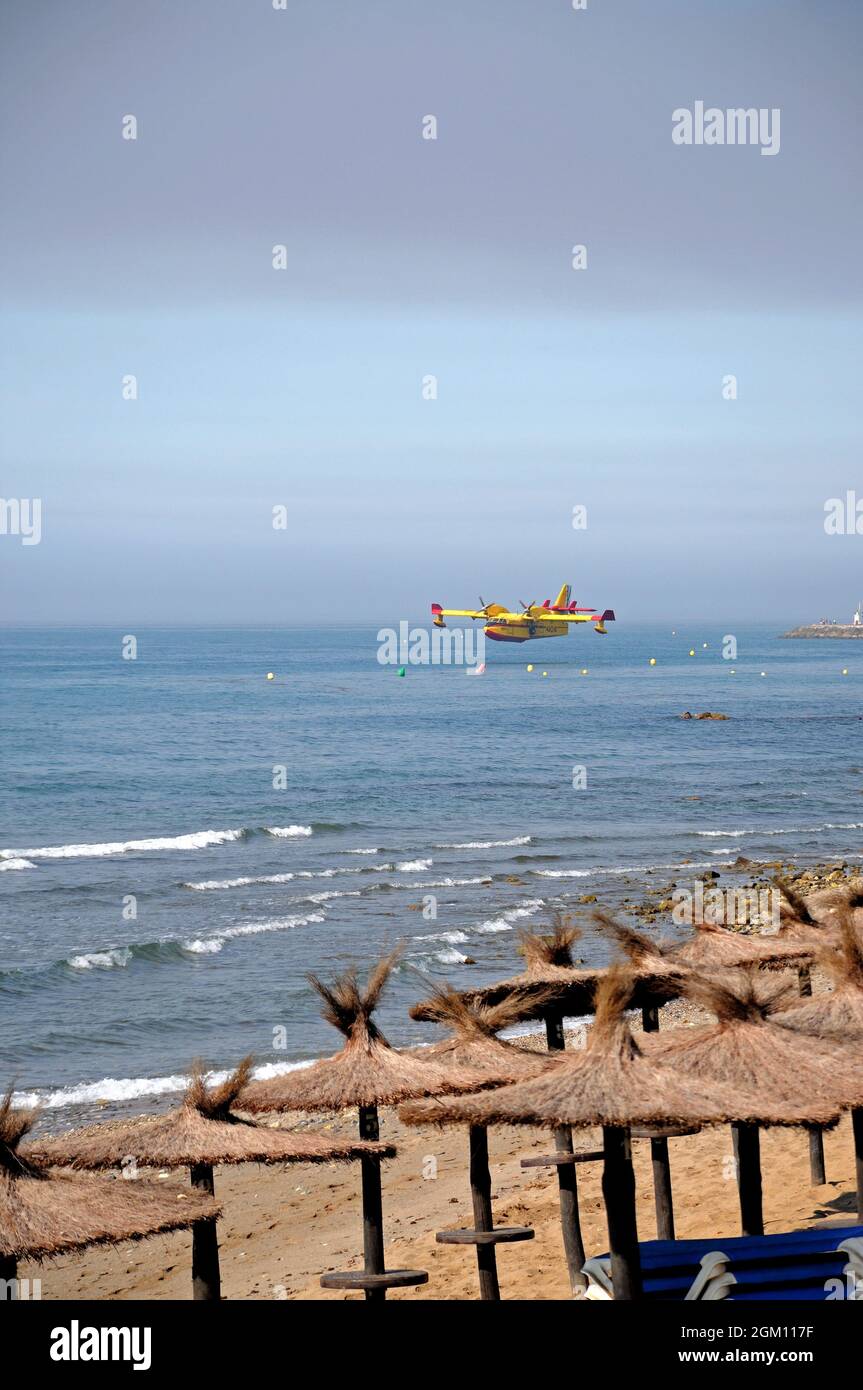 Fire bomber collecting water from the sea to tackle bush fires ...