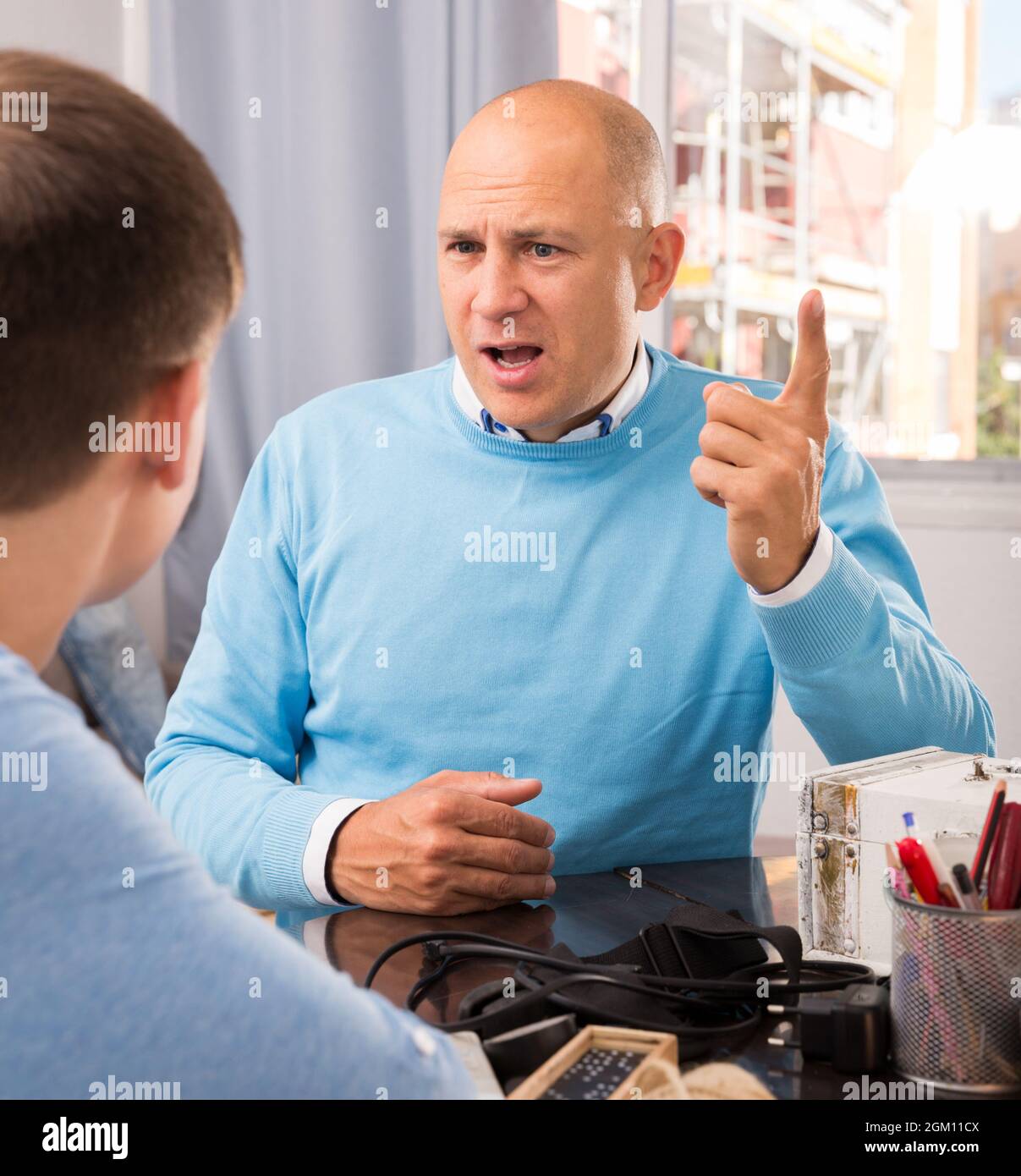 Strict father talking to son Stock Photo - Alamy