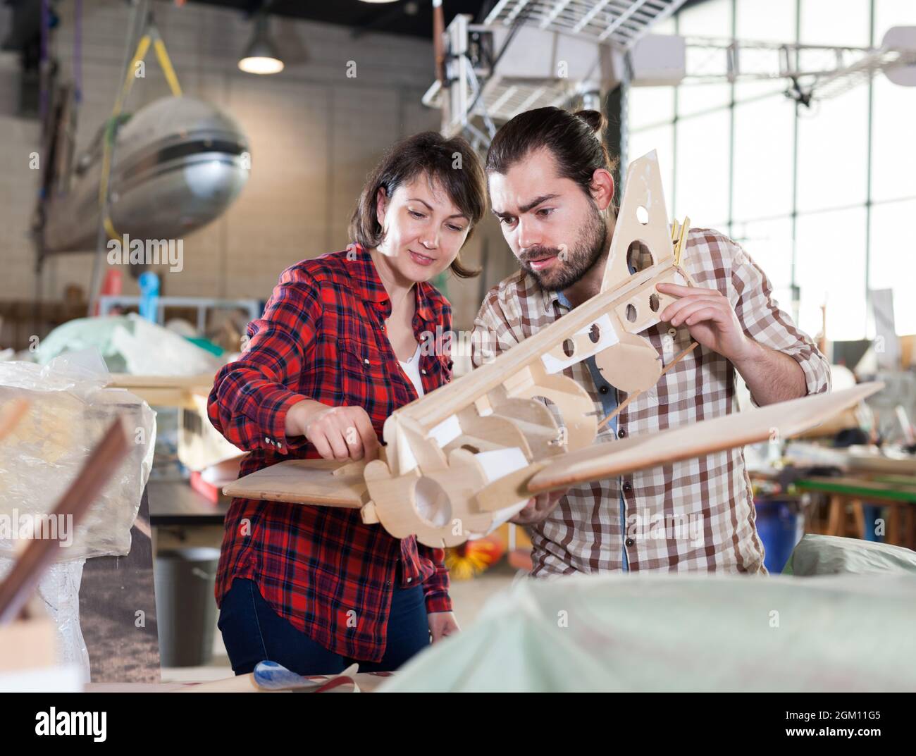 Team creating airplane models Stock Photo - Alamy