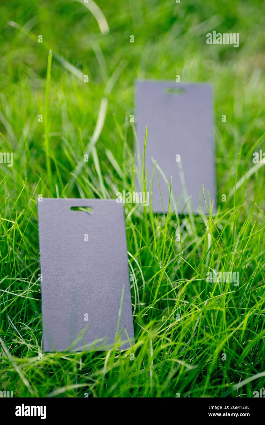 Side view of two black price tags for clothing creative layout of lawn ...