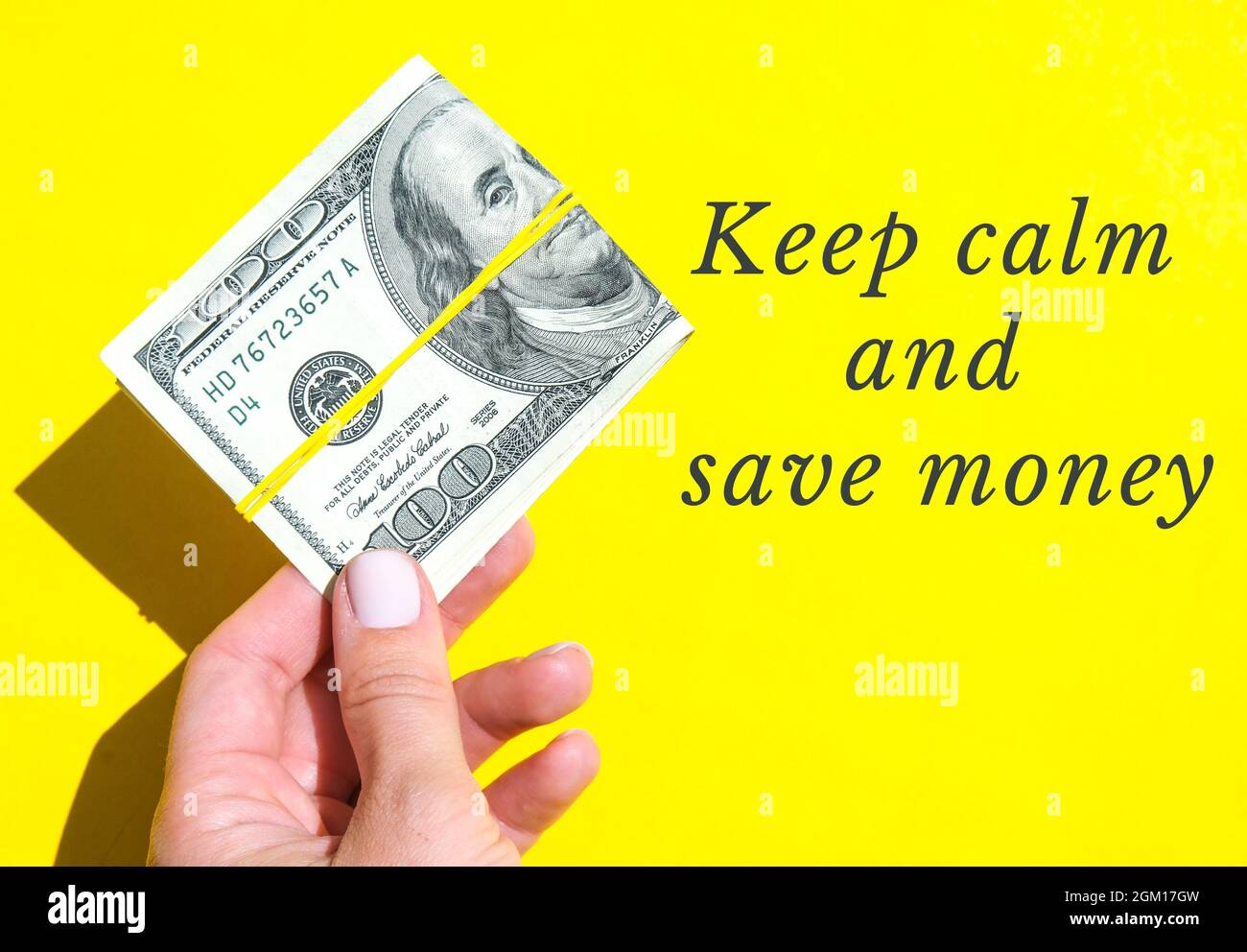 KEEP CALM AND SAVE MONEY Quote Female hand holding dollars close up ...