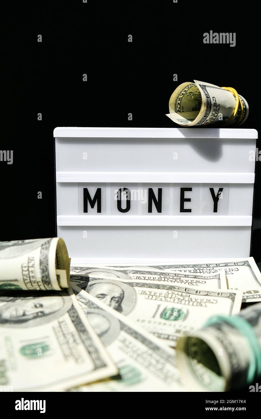 Lightbox board with the word MONEY in black letters around Us dollars ...