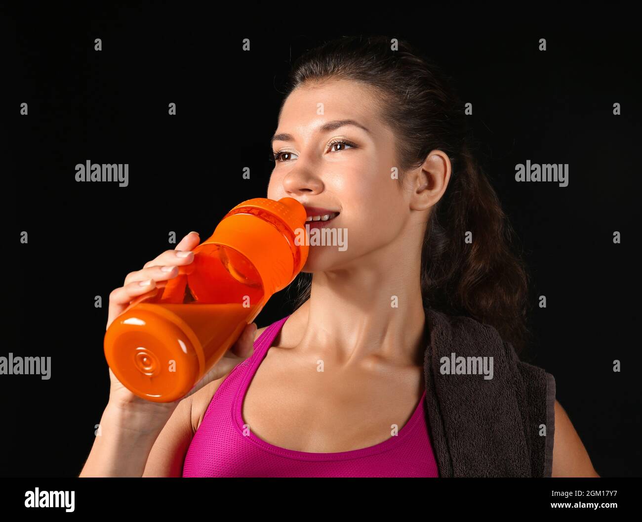 Beautiful young woman drinking protein shake on black background Stock ...