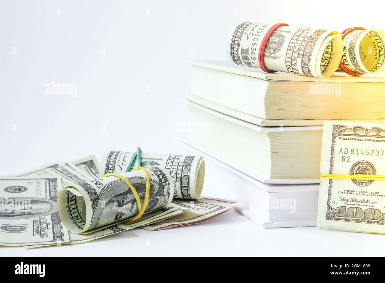Knowledge leads to wealth. Stack of books with dollars. Concept of ...