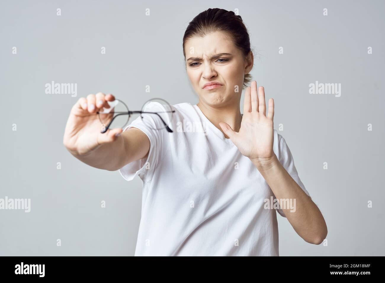 woman in white t-shirt glasses poor eyesight close-up Stock Photo - Alamy