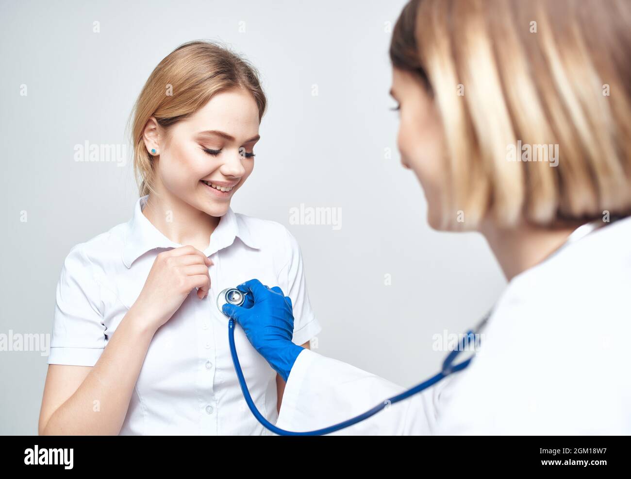 nurse stethoscope healing procedures light background Stock Photo - Alamy