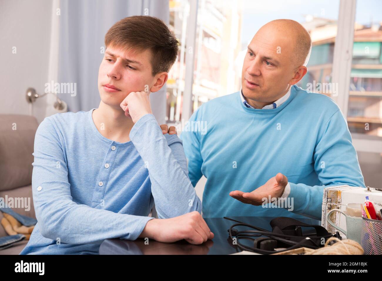 Father supporting his upset son Stock Photo - Alamy