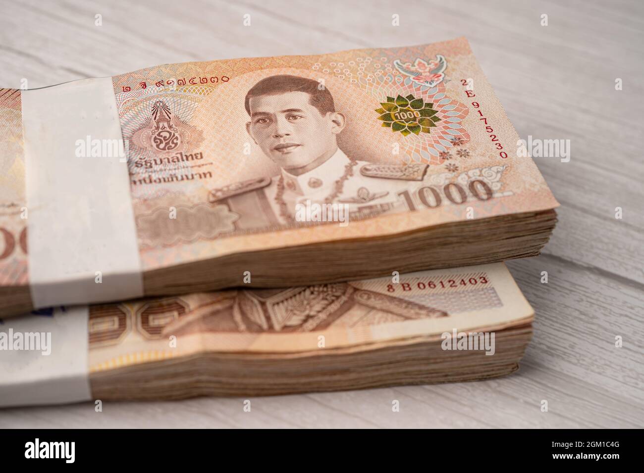 Stack of Thai baht banknotes on wooden background, business saving ...