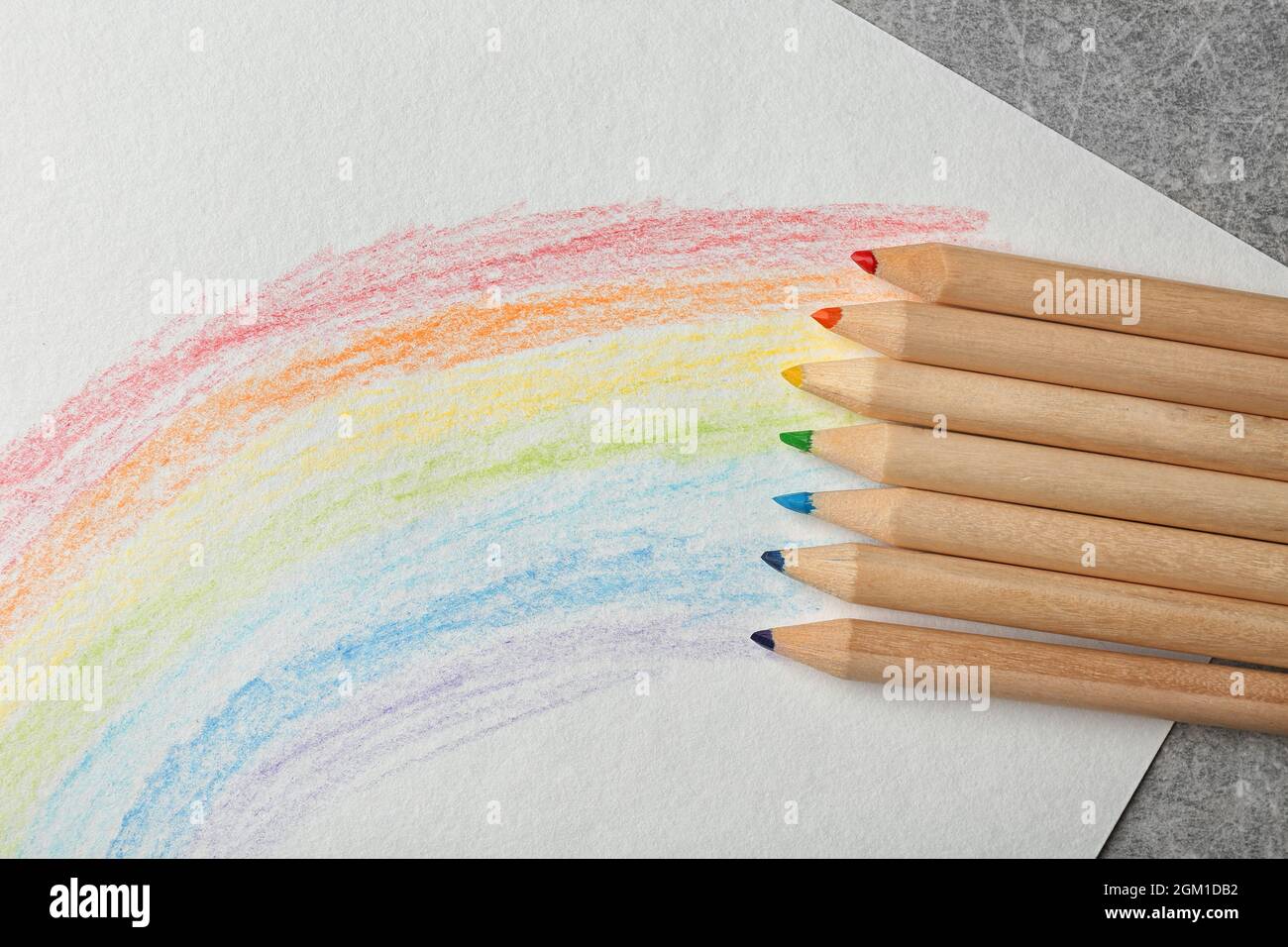 Beautiful drawing of rainbow and color pencils on grey background ...