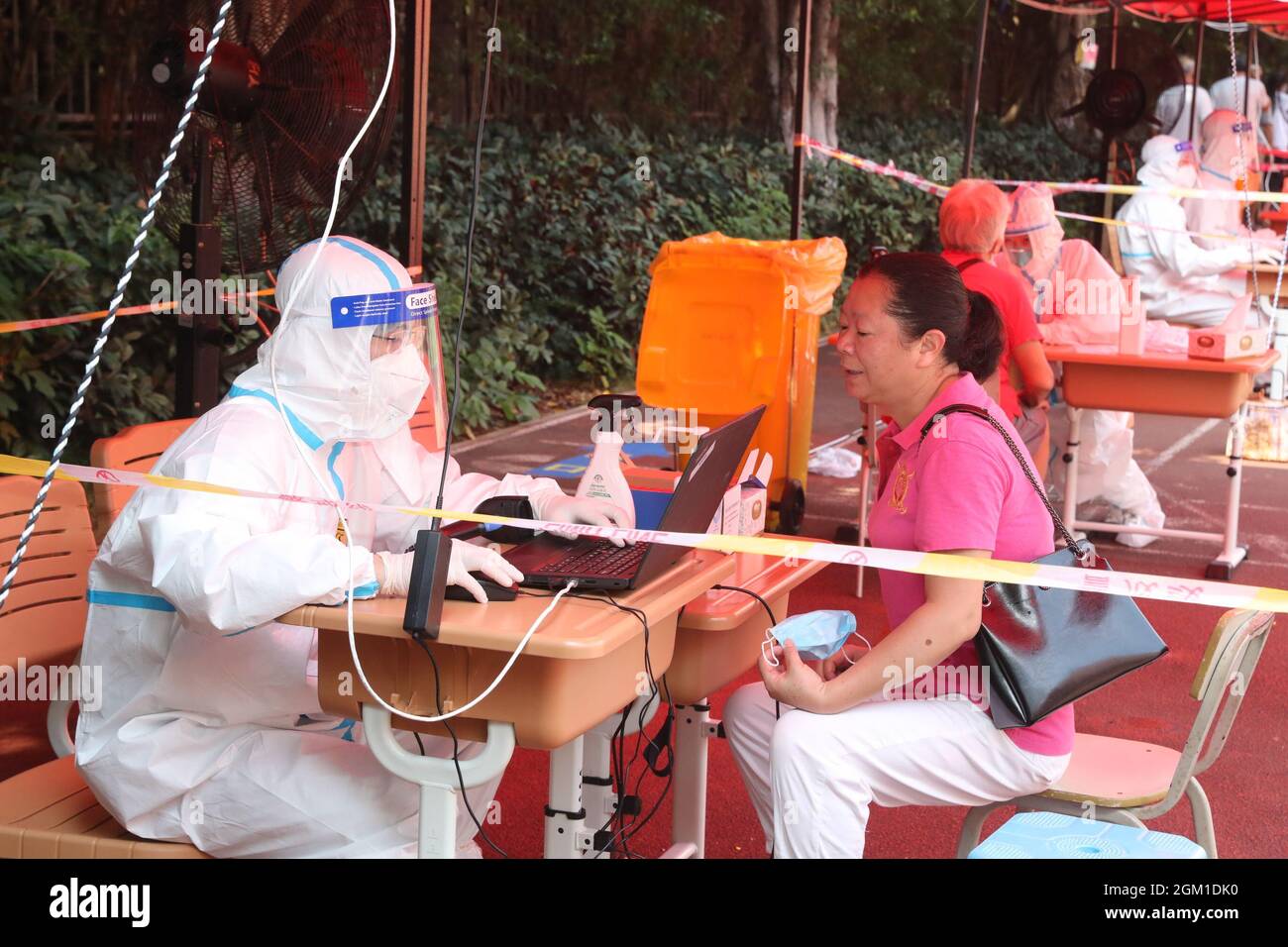 Medical professionals work at a mobil nucleic acid test cabin built in ...