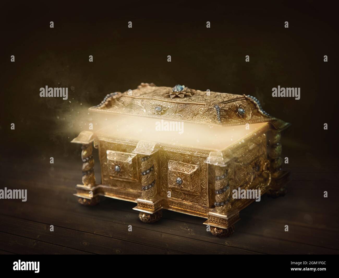 Golden open box with light on dark background Stock Photo - Alamy