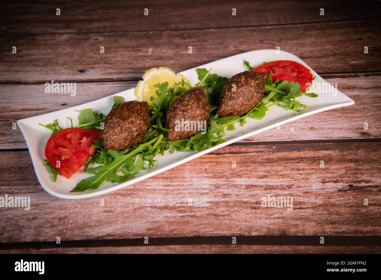 Traditional kebbe and pita bread on big round plate in lebanese ...