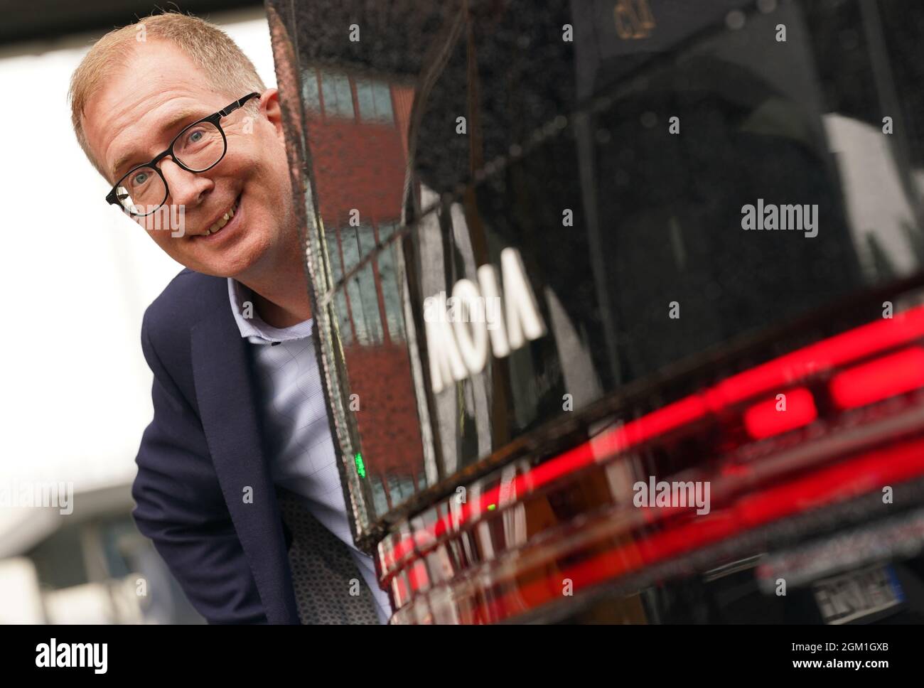 Hamburg, Germany. 15th Sep, 2021. Robert Henrich, CEO of Moia, stands by a shared taxi at the ...