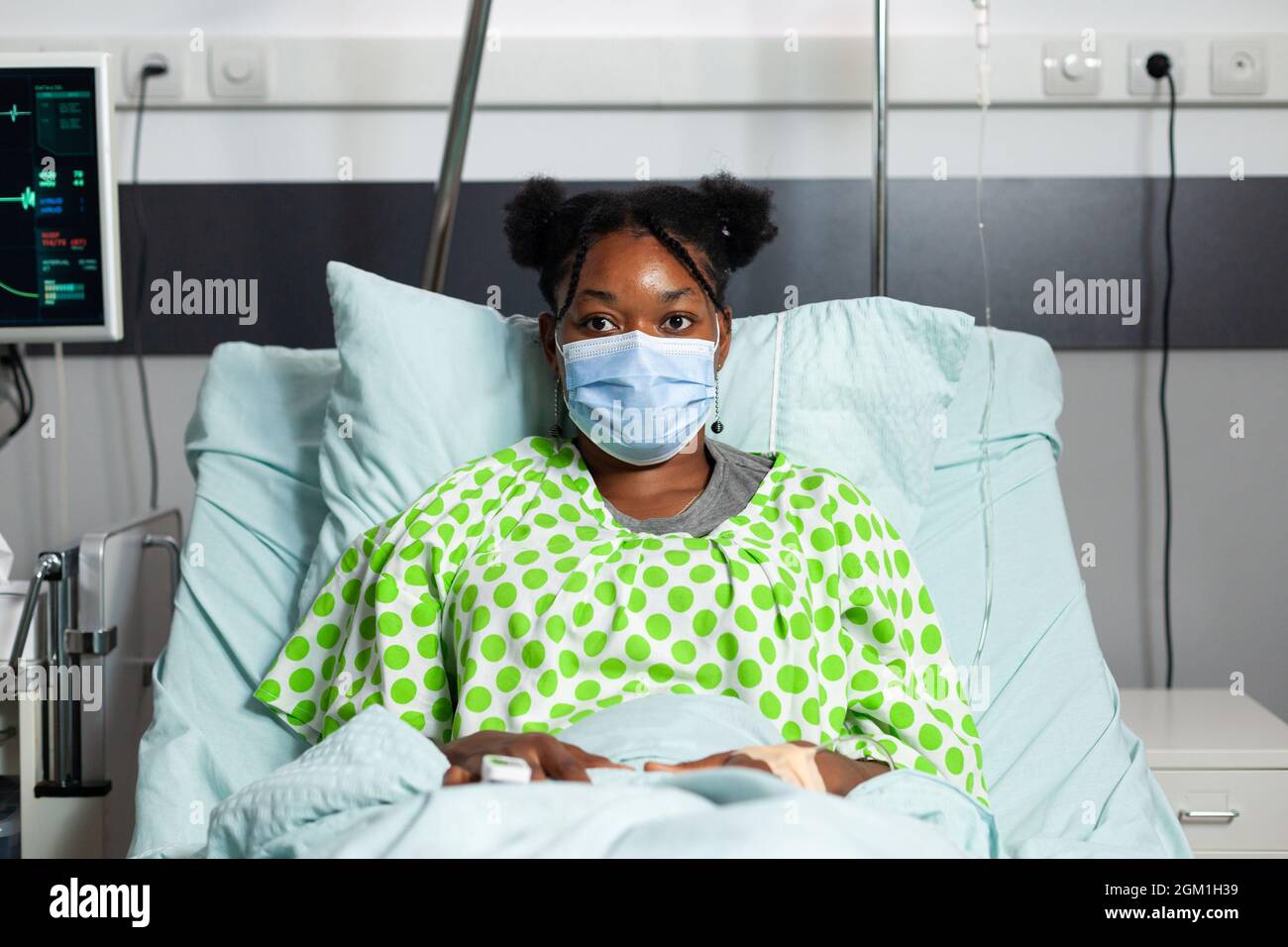 Portrait of african american patient with face mask looking at camera ...