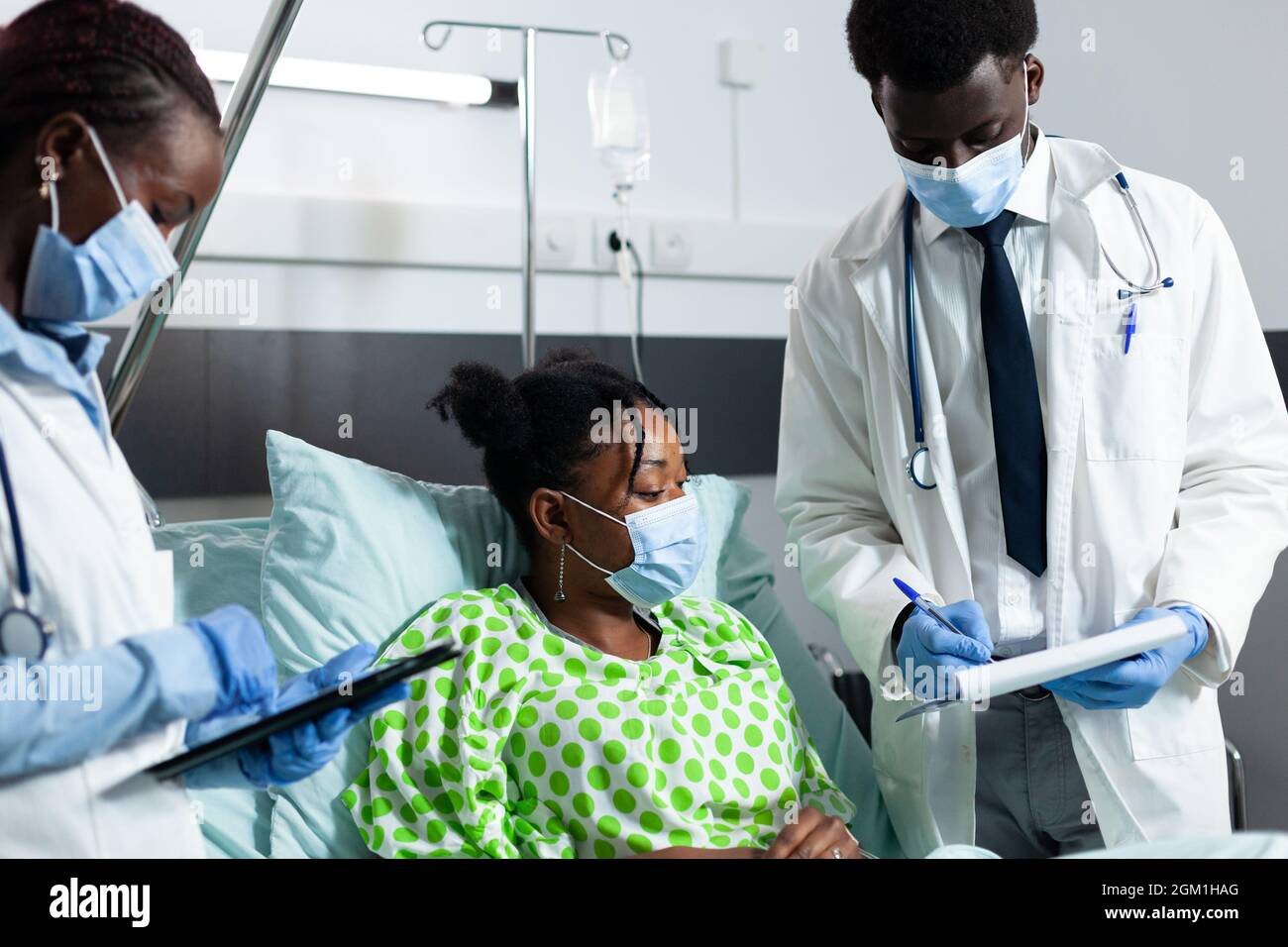 African american team of doctors examining patient disease in hospital ...