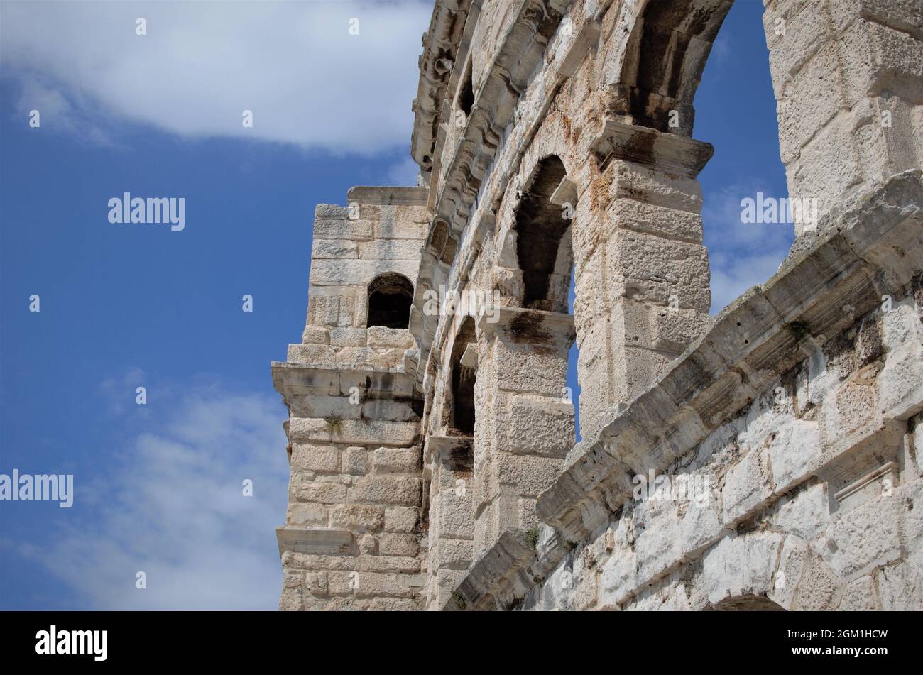 Pula Amphitheater detail with blue sky Stock Photo - Alamy