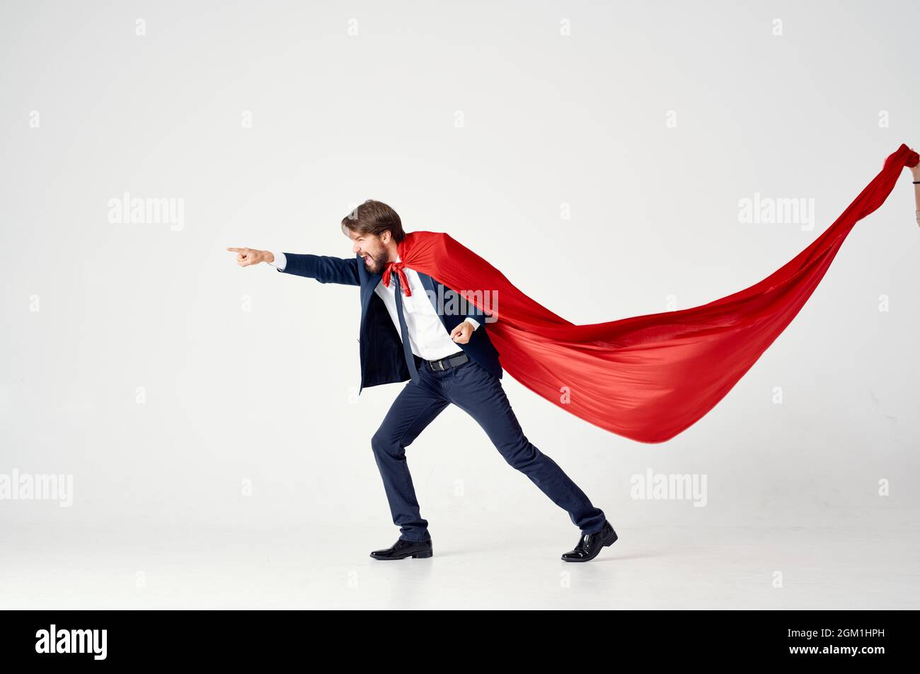 man in suit with red cloak superhero power protection Stock Photo - Alamy