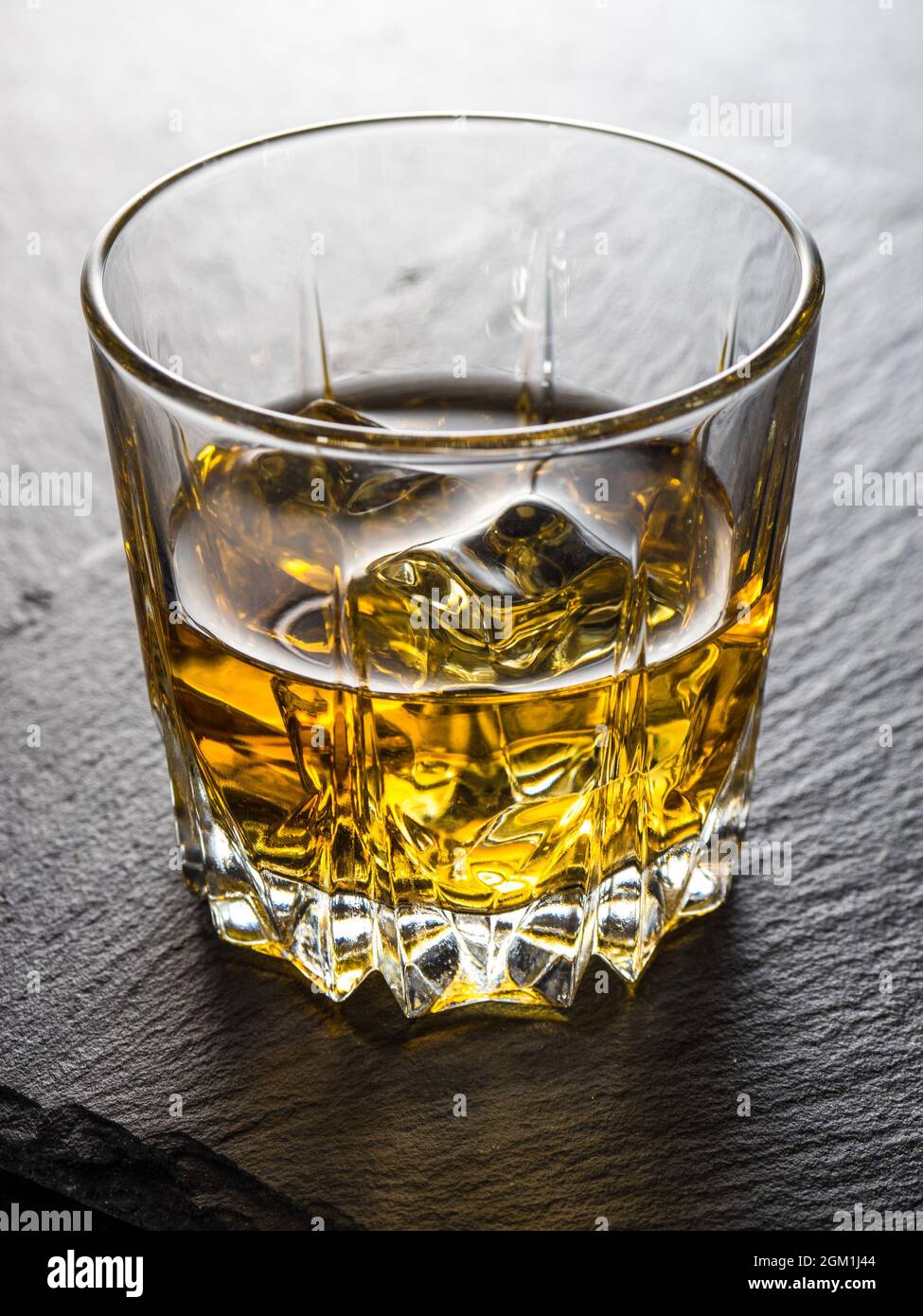 Whisky on the rocks on black slate surface Stock Photo - Alamy
